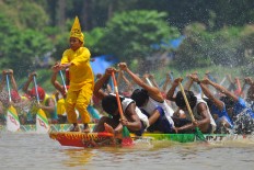 A ‘tukang tari’ (bow dancer) leads a team of rowers in Pacu Jalur, a traditional boat race featuring ‘jalur’ (wooden longboat) of between 25 and 40 meters long, in this undated handout photo from the Tourism and Culture Office of Kuantan Singingi regency, Riau province.