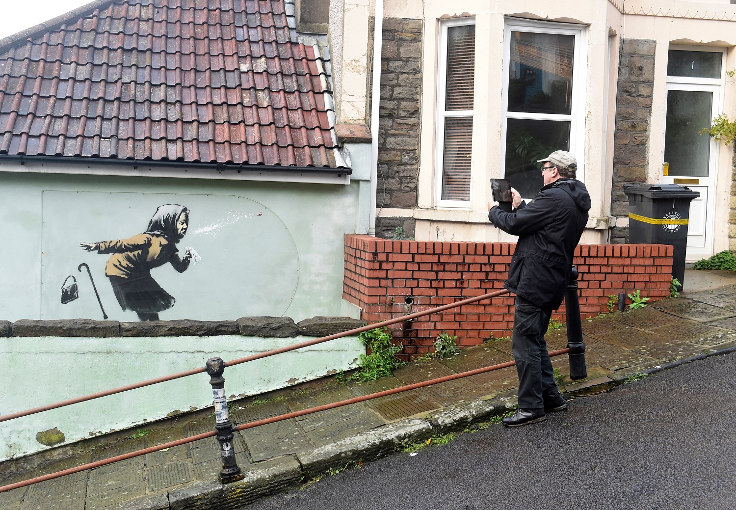 Banksy mural of sneezing woman appears on England's steepest street ...