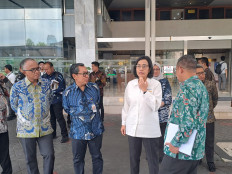 Finance Minister Sri Mulyani Indrawati (second right) waits for her car at the House of Representatives complex in Central Jakarta on July 8, 2024.