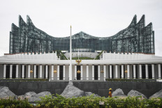 A worker walks in front of the State Palace on Nov. 10, 2024, at the government offices complex in the Nusantara Capital City (IKN) in North Penajam Paser, East Kalimantan. President Prabowo Subianto has said that within the next five years, he will make the new capital city the center of government political activities, where most of his administration’s executive, legislative and judicial activities will take place