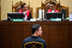 Thomas Lembong, accused in a corruption case involving raw sugar imports, attends the reading of the indictment on March 6 at the Jakarta Corruption Court.