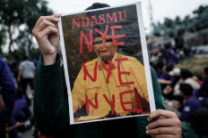 A university student holds a poster bearing the term “Ndasmu“, a highly derogatory Javanese word that literal translation as “your head“, during an Indonesia Gelap (Dark Indonesia) protest against President Prabowo Subianto's administration in Jakarta on Feb. 20, 2025.