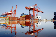 Containers and cranes are seen on April 13 at the container port in Lianyungang, in China's eastern Jiangsu province. China said on April 14, that exports soared 12.4 percent year-on-year last month, beating expectations as Beijing navigated mounting trade headwinds sparked by United States President Donald Trump.