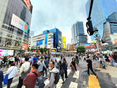 People cross the street in the Shibuya area of Tokyo on Sept. 25, 2024.