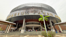 People lounge atop the stairs leading the new building at Tanah Abang Station in Central Jakarta on June 29, 2025, the day it opened.