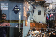Fatal flaw: A group of people gathers on July 19, 2025, at the site of a house destroyed by fire on Jl. Kutilang in Bukit Duri, Tebet, South Jakarta. Four children were killed and four other people were injured in the fire that engulfed three rented houses, according to data from the South Jakarta Fire and Rescue Agency.