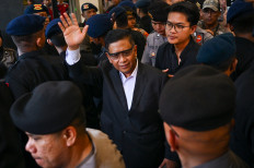 Indonesian Democratic Party of Struggle (PDI-P) secretary general Hasto Kristiyanto (center) waves to crowds after hearing the verdict for his trial at the Corruption Court, Jakarta, on July 25. The panel of judges found him guilty of bribery and sentenced him to three years and six months in prison and a fine of Rp 250 million. 