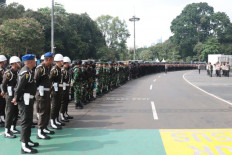 Joint security officers stand at the ready on July 29 during a briefing ahead of the 2025 ASEAN U-23 Championship final match between Indonesia and Vietnam at the Gelora Bung Karno (GBK) Main Stadium in Jakarta. Vietnam won the championship after defeating Indonesia 1-0.